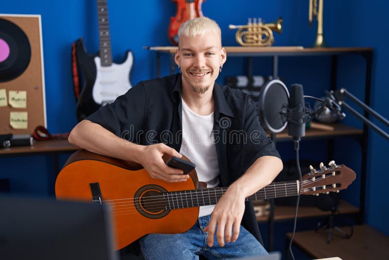 Young Caucasian Man Musician Playing Classical Guitar Using Smartphone ...