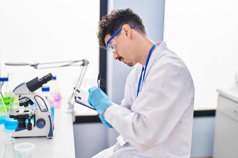 Young Caucasian Man Scientist Writing Report Working at Laboratory ...