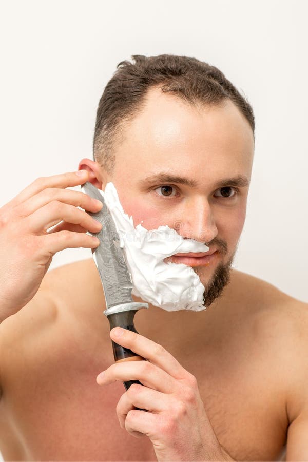 Young Caucasian Man Shaving Beard with a Big Knife on White Background ...