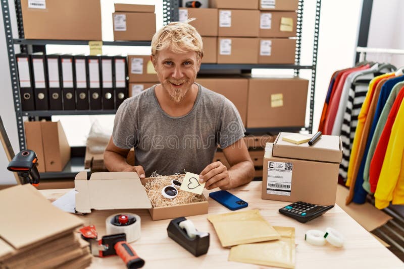 Young Caucasian Man Smiling Confident Packing Order at Warehouse Stock ...