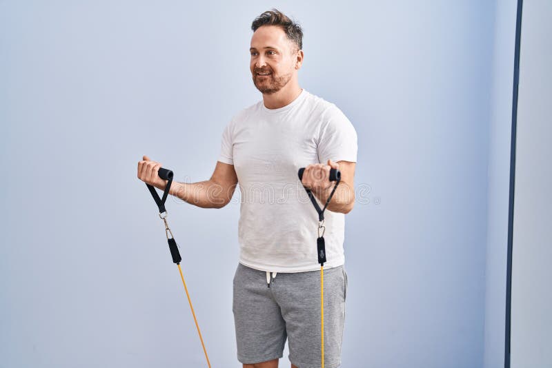 Young Caucasian Man Smiling Confident Using Elastic Band Training at ...