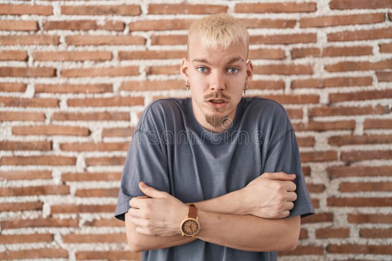Young Caucasian Man Standing Over Bricks Wall Shaking and Freezing for ...