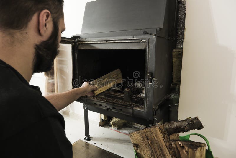 Young Caucasian Man Starting a Fire in Fireplace Stock Photo - Image of ...