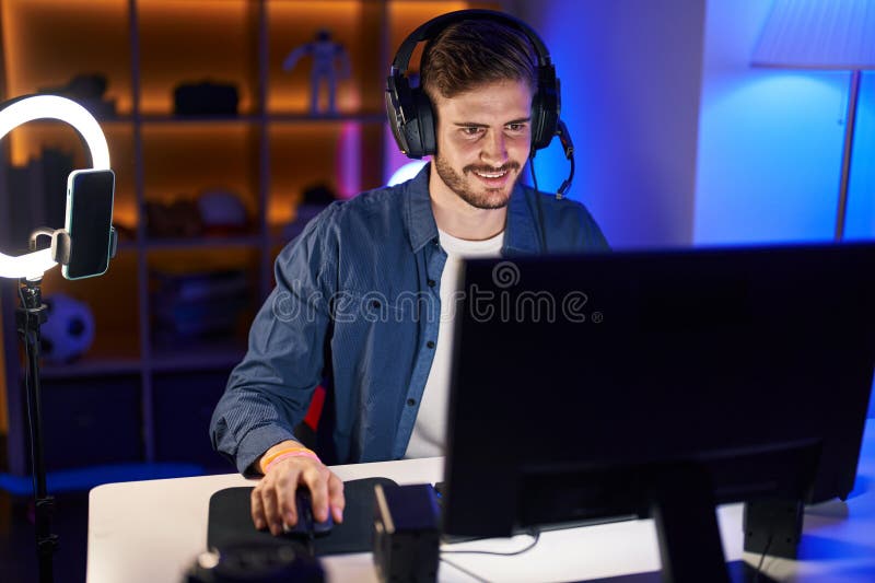 Young Caucasian Man Streamer Playing Video Game Using Computer at ...