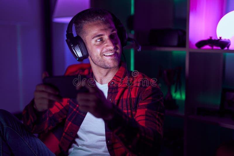 Young Caucasian Man Streamer Playing Video Game Using Smartphone at ...