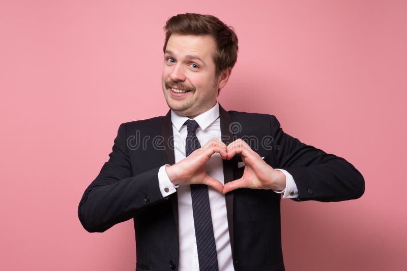 Young Caucasian Man In Suit Doing A Heart Gesture Stock Image - Image ...