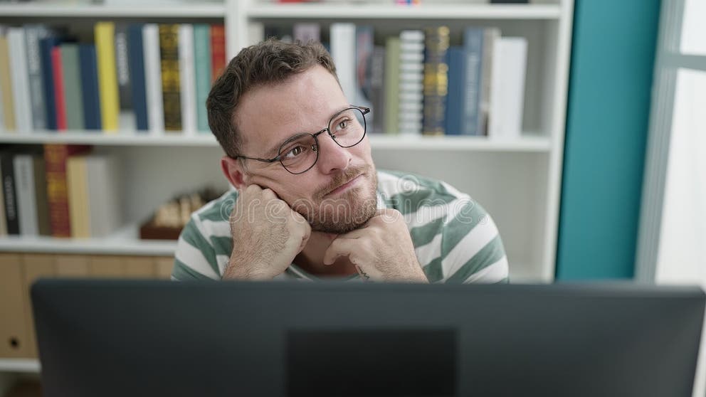 Young Caucasian Man Using Computer Thinking at Library University Stock ...