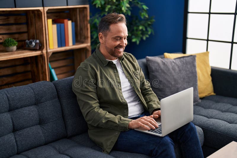Young Caucasian Man Using Laptop Sitting on Sofa at Home Stock Photo ...