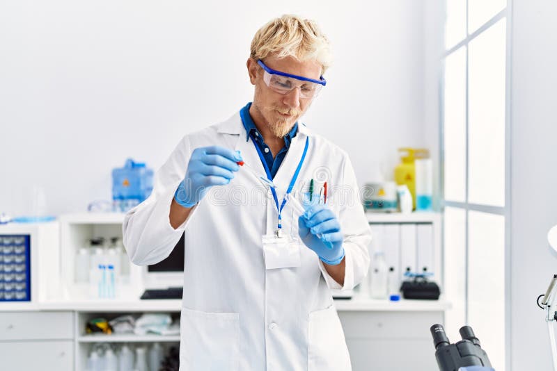 Young Caucasian Man Wearing Scientist Uniform Using Pipette at ...