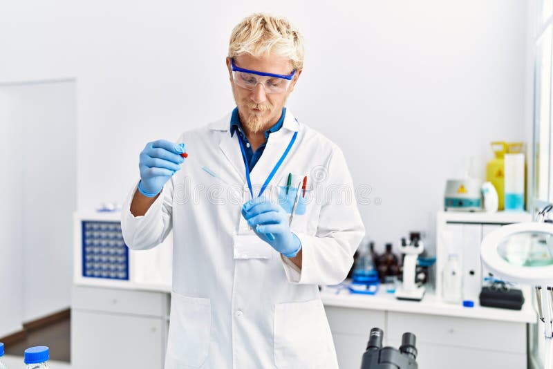 Young Caucasian Man Wearing Scientist Uniform Using Pipette at ...