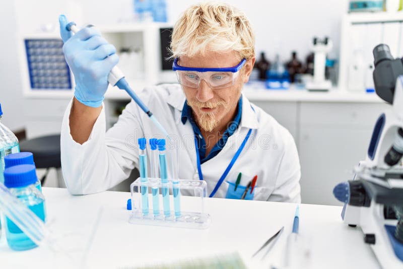 Young Caucasian Man Wearing Scientist Uniform Using Pipette at ...