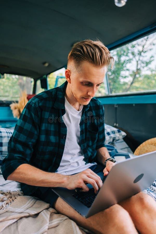 Young Caucasian Man Work on Computer Sitting in a Van, Freelancer Using ...
