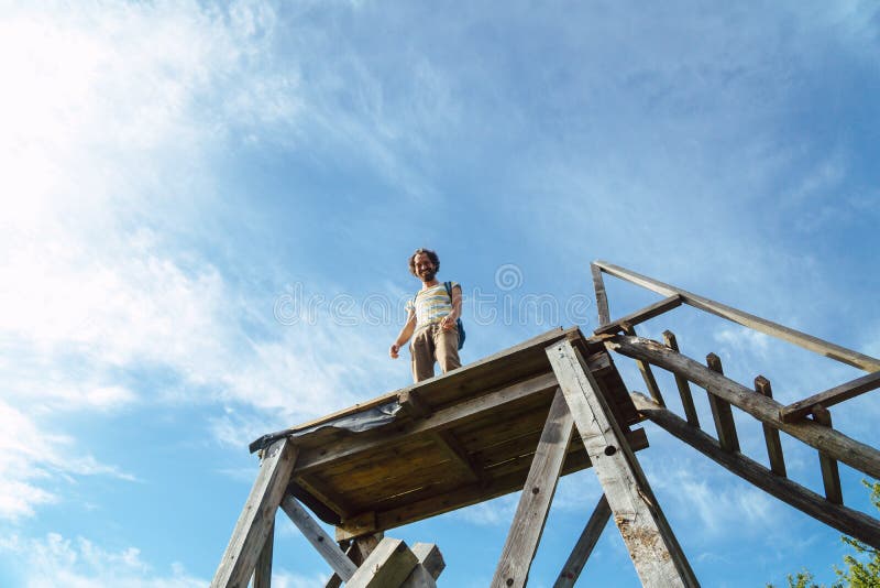 Young Caucasian Standing on a High Stand Smiling Down Stock Image ...