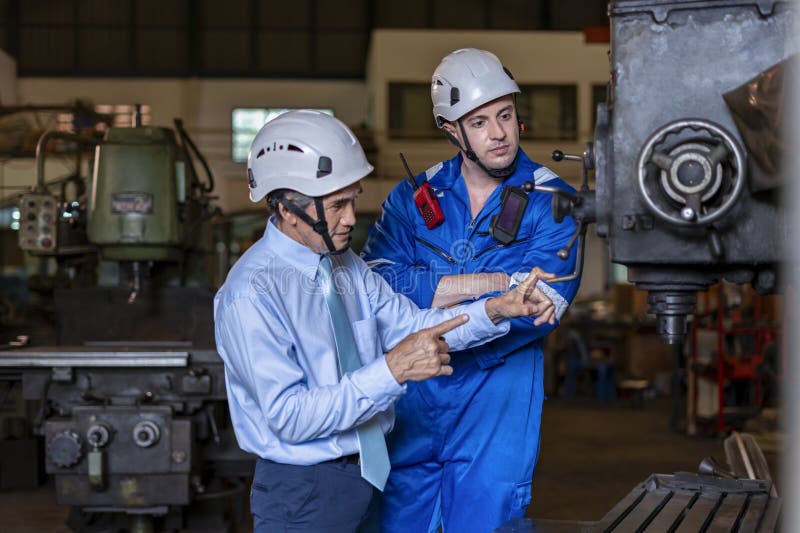 Young Caucasian Technician Talking with Old Experience Manager Who ...