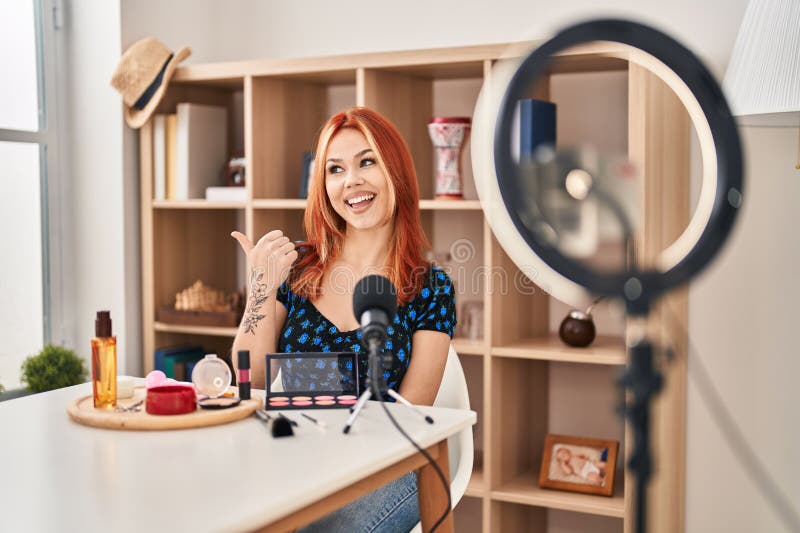 Young Caucasian Woman Applying Make Up Doing Tutorial Smiling with ...