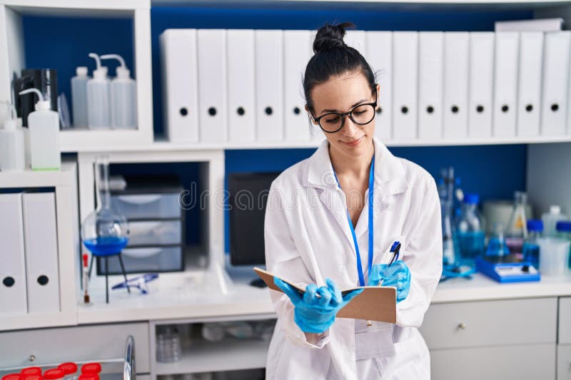Young Caucasian Woman Scientist Smiling Confident Writing on Notebook ...