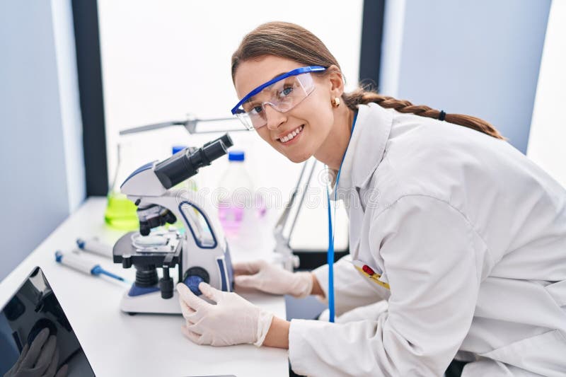 Young Caucasian Woman Scientist Using Microscope at Laboratory Stock ...
