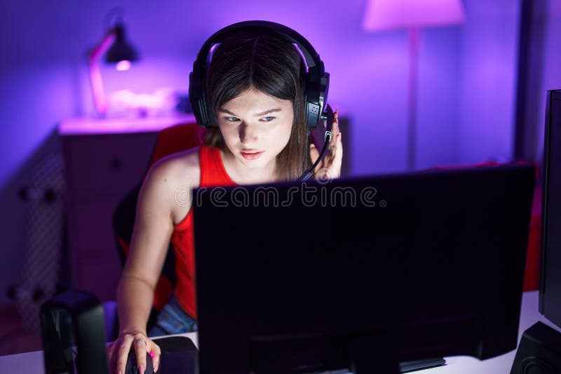 Young Caucasian Woman Streamer Playing Video Game Using Computer at ...