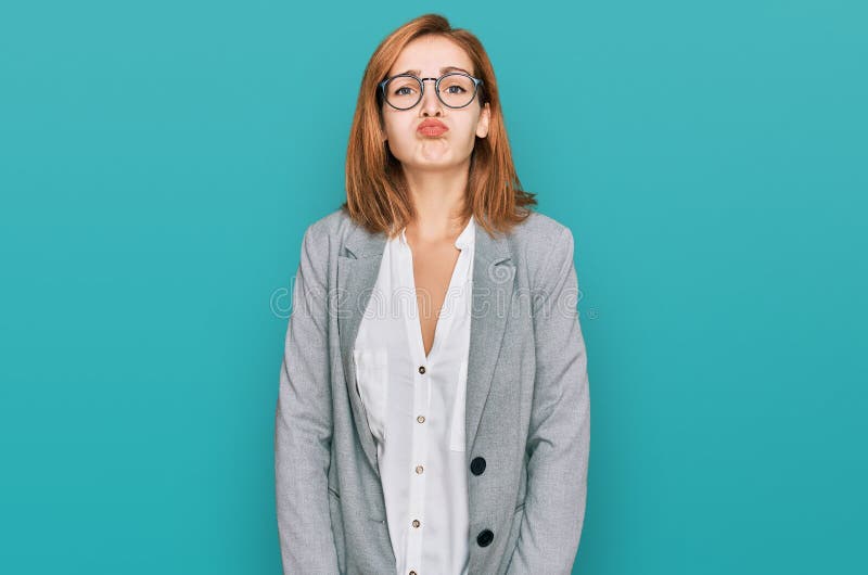 Young Caucasian Woman Wearing Business Style and Glasses Puffing Cheeks ... Young Caucasian Woman Wearing Business Style and Glasses Puffing Cheeks ...