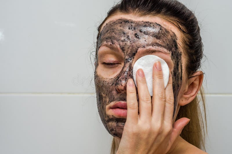 Young Charming Girl Makes a Black Charcoal Mask on Her Face Stock Photo ...