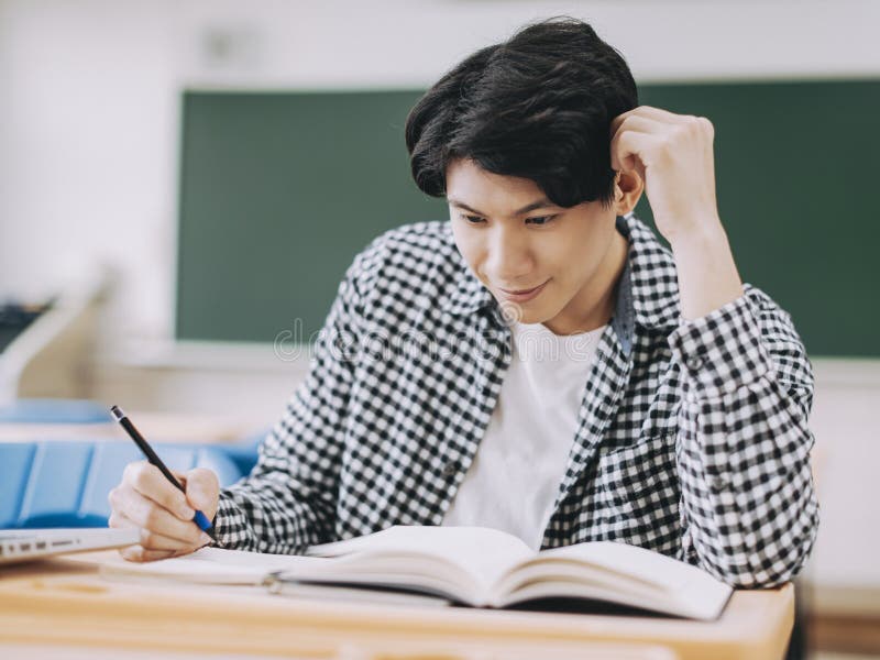 Young Cheerful Asian Student Studying in Classroom Stock Image - Image ...