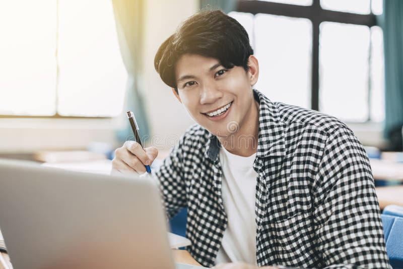 Young Cheerful Asian Student Studying in Classroom Stock Photo - Image ...