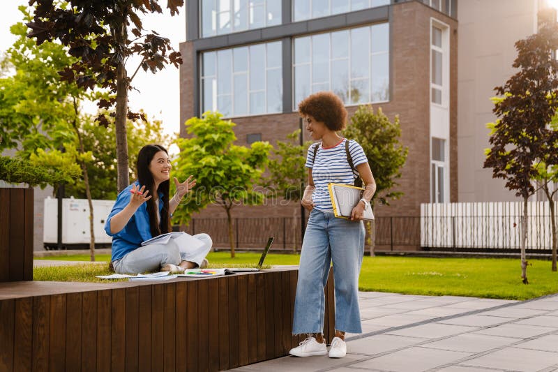 Young Cheerful Female Students Talking after Classes in Campus Stock ...