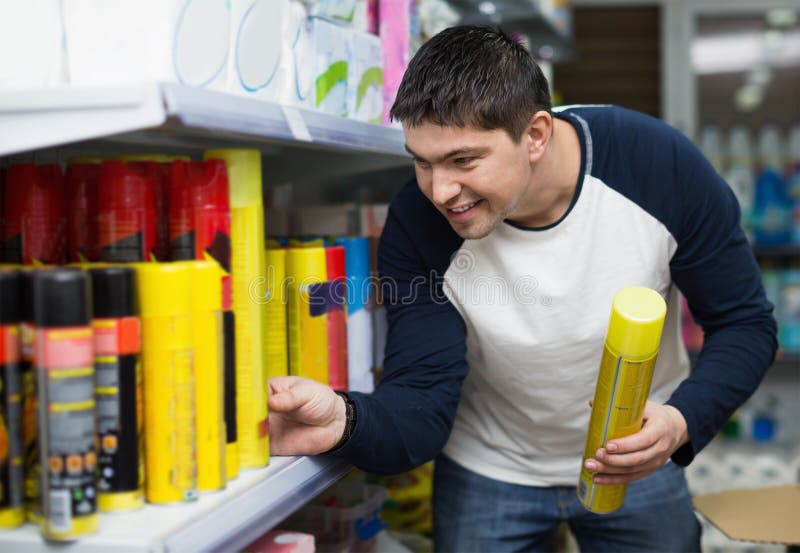 Young Cheerful Man Choosing Insects Killer Spray Stock Photo - Image of ...