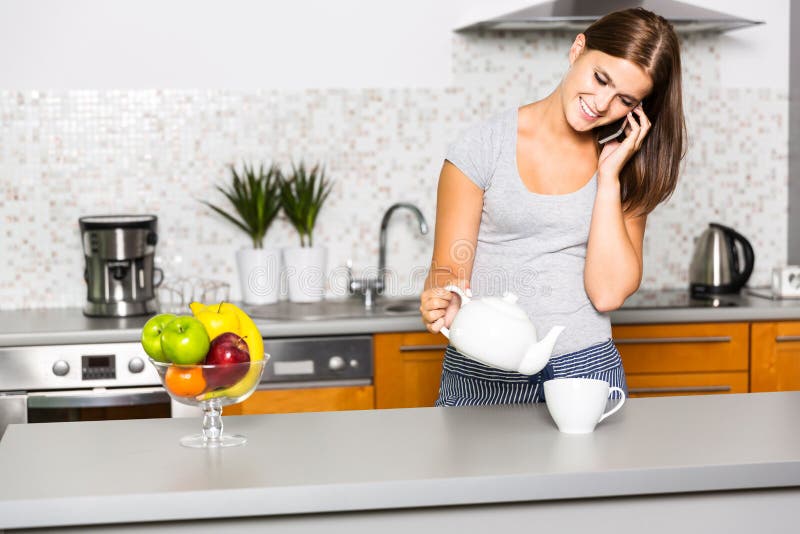 Young Cheerful Woman Talking on the Phone in Kitchen Stock Image ...