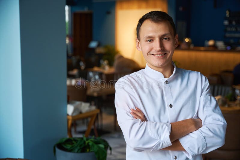 Young Chef in a Chefs Uniform Stands in Restaurant Hall Stock Photo ...