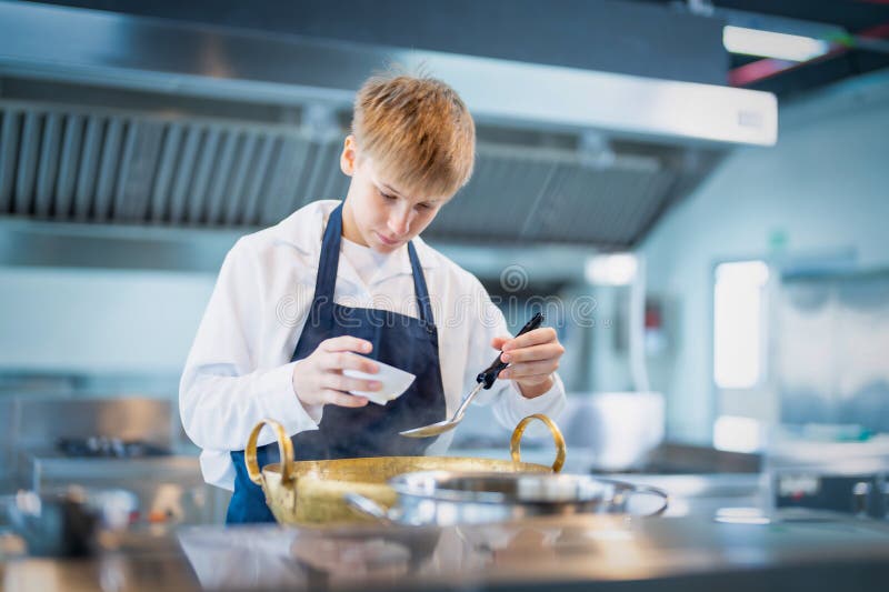 Young Chef Cooking at Restaurant Kitchen Stock Photo - Image of ...