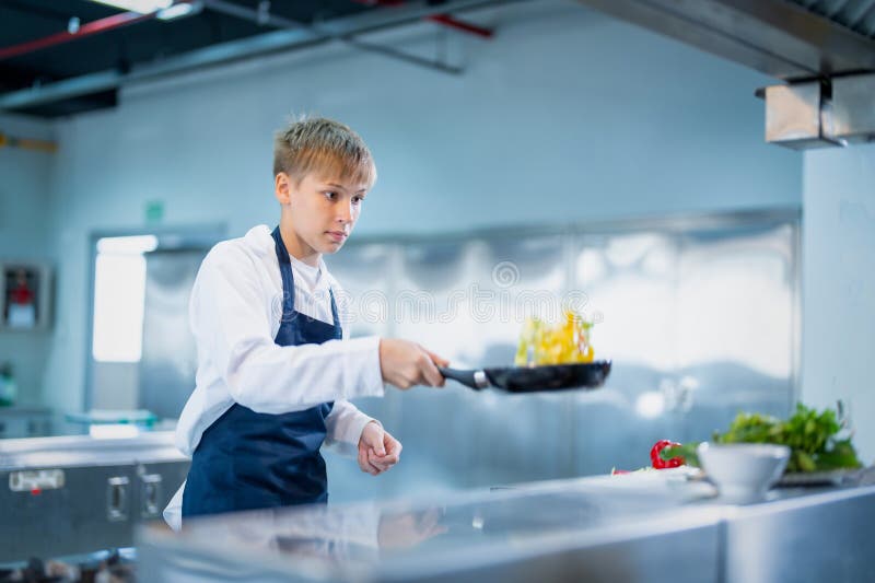 Young Chef Cooking at Restaurant Kitchen Stock Image - Image of ...