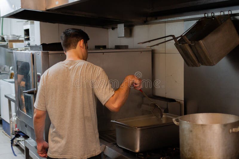 Young Chef Making Food Production for Restaurant Kitchen Stock Image ...