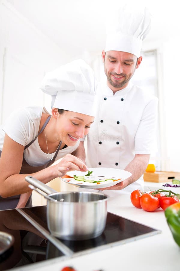 Young Chef Training a Young Attractive Girl To Cook Stock Image - Image ...