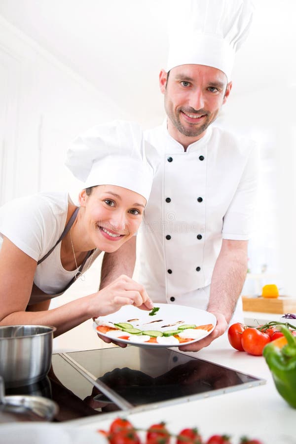 Young Chef Training a Young Attractive Girl To Cook Stock Image - Image ...