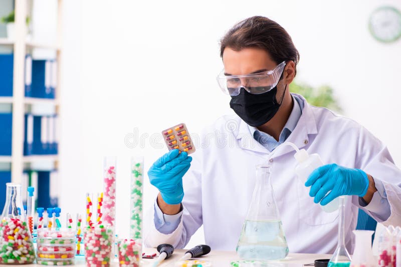 Young Male Chemist in Drug Synthesis Concept Stock Image - Image of ...