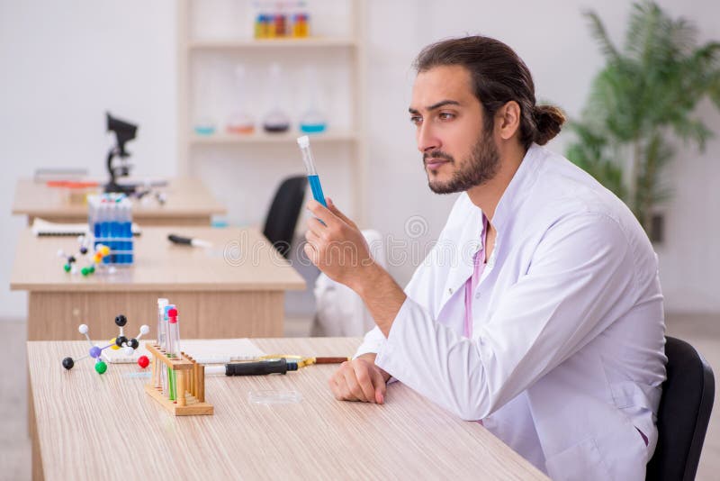 Young Male Chemist Sitting at the Desk in the Classroom Stock Image ...