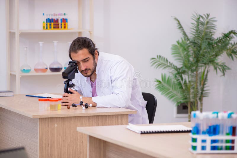 Young Male Chemist Sitting at the Desk in the Classroom Stock Photo ...