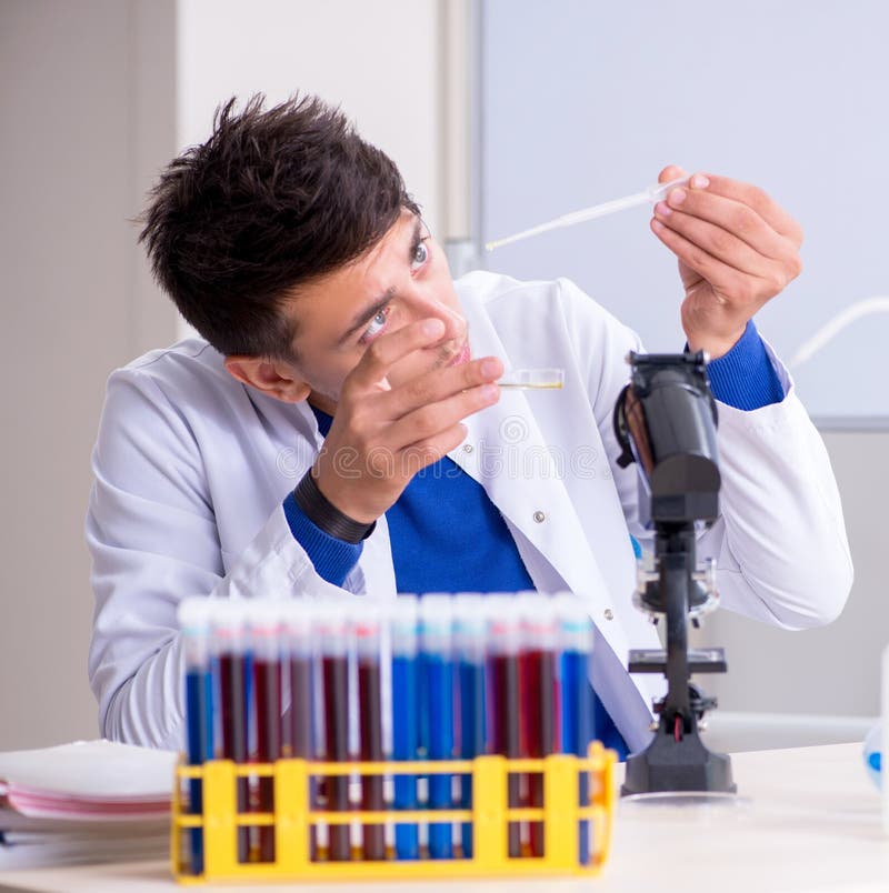 The Young Chemist Sitting in the Lab Stock Photo - Image of glassware ...