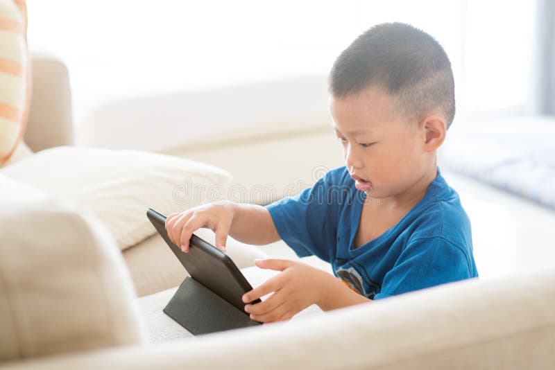 Young Child Addicted To Tablet. Stock Photo - Image of family ...