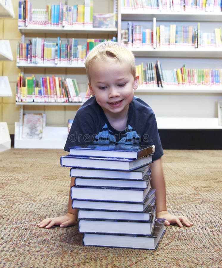 Young Child Excited about Reading His Stack of Books at the Library ...