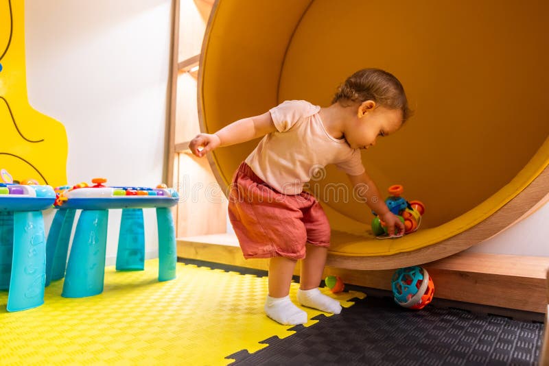 Young Child Exploring Toys and Activity Centers in a Vibrant and ...