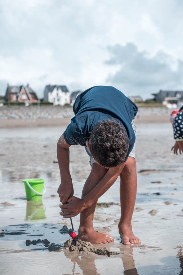 Young Child Playing on the Beach, Constructing a Sand Castle with ...
