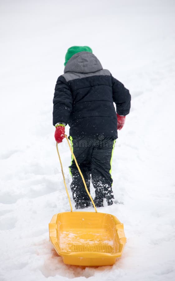 Child Pulling Sledge through Winter Landscape Stock Photo - Image of ...