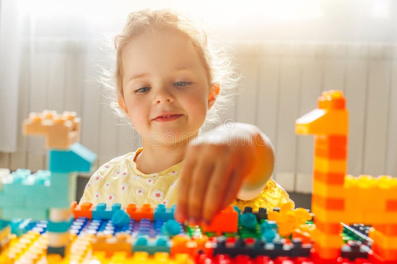Young Child Reaches for Colorful Construction Blocks To Build and Play ...