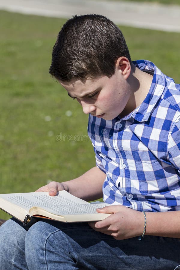 Young Child Reading a Book in the Woods with Shallow Depth of Field and ...