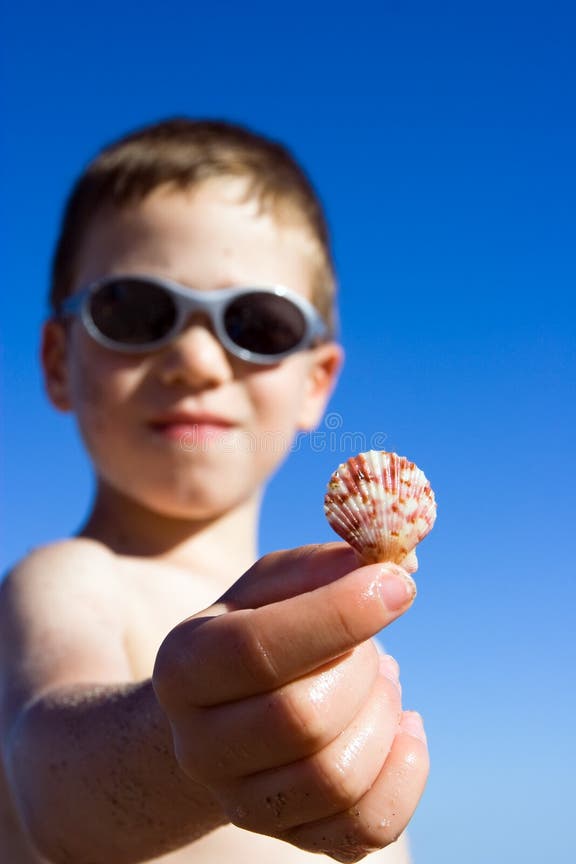 Young Child Showing a Shell Stock Image - Image of colorful, people ...