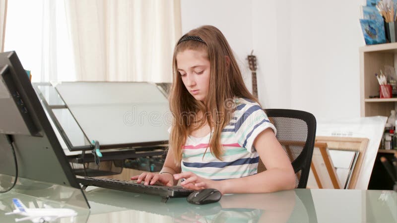 Young Child Sitting at Desk in Front of Computer Typing Online Homework ...