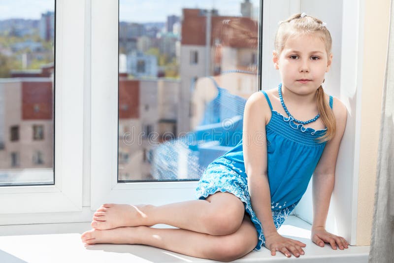 Young Child Sitting on Window Sill in Sun Light Stock Image - Image of ...