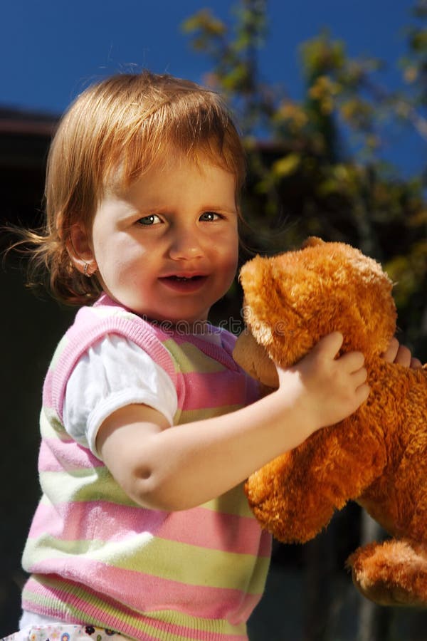 Young Child with Teddy Bear Stock Image - Image of playful, outside ...